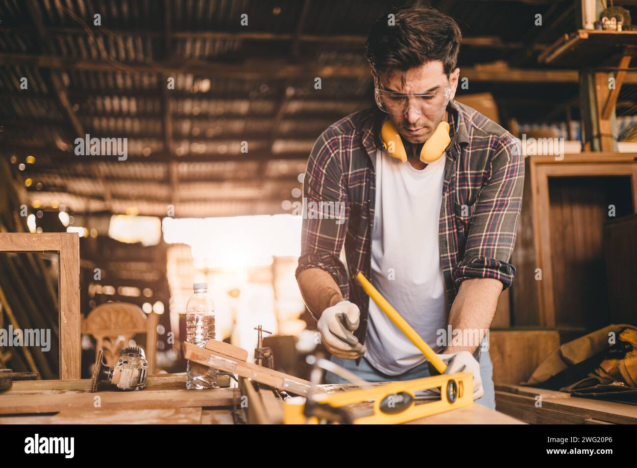 Carpenter hand made wooden furniture in workshop. Male worker 40s ...