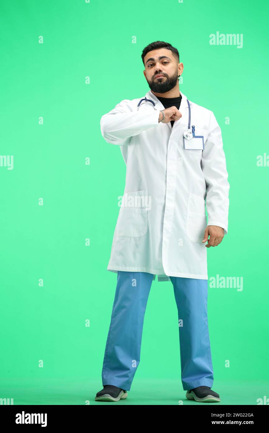 The doctor, in full height, on a green background, hits his chest Stock ...