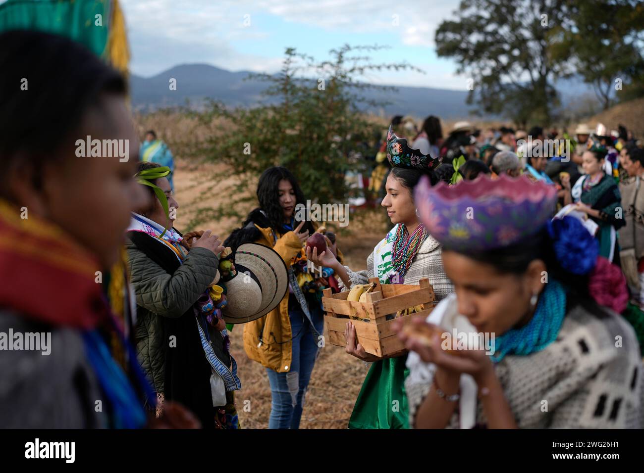 Purepecha Indigenous people pass out fruit after holding a ceremony ...