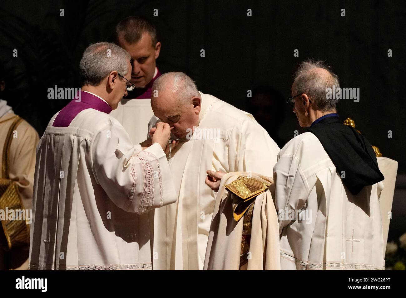Pope Francis is helped wear his vestments as he presides over a mass ...