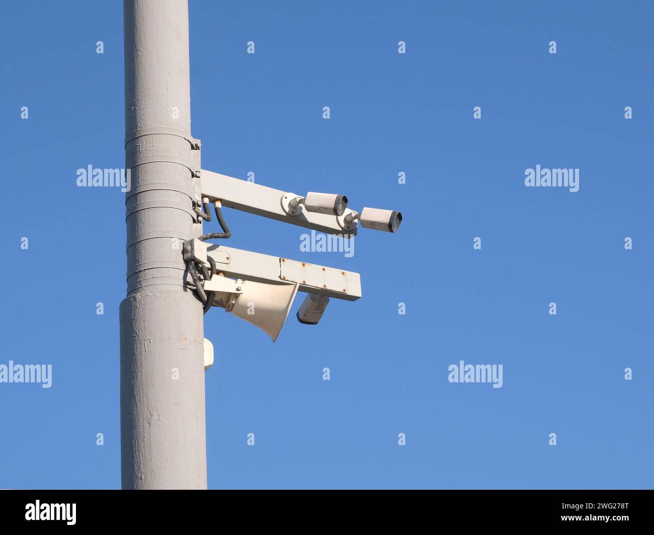Traffic control road cameras mounted on the pole against clear blue ...