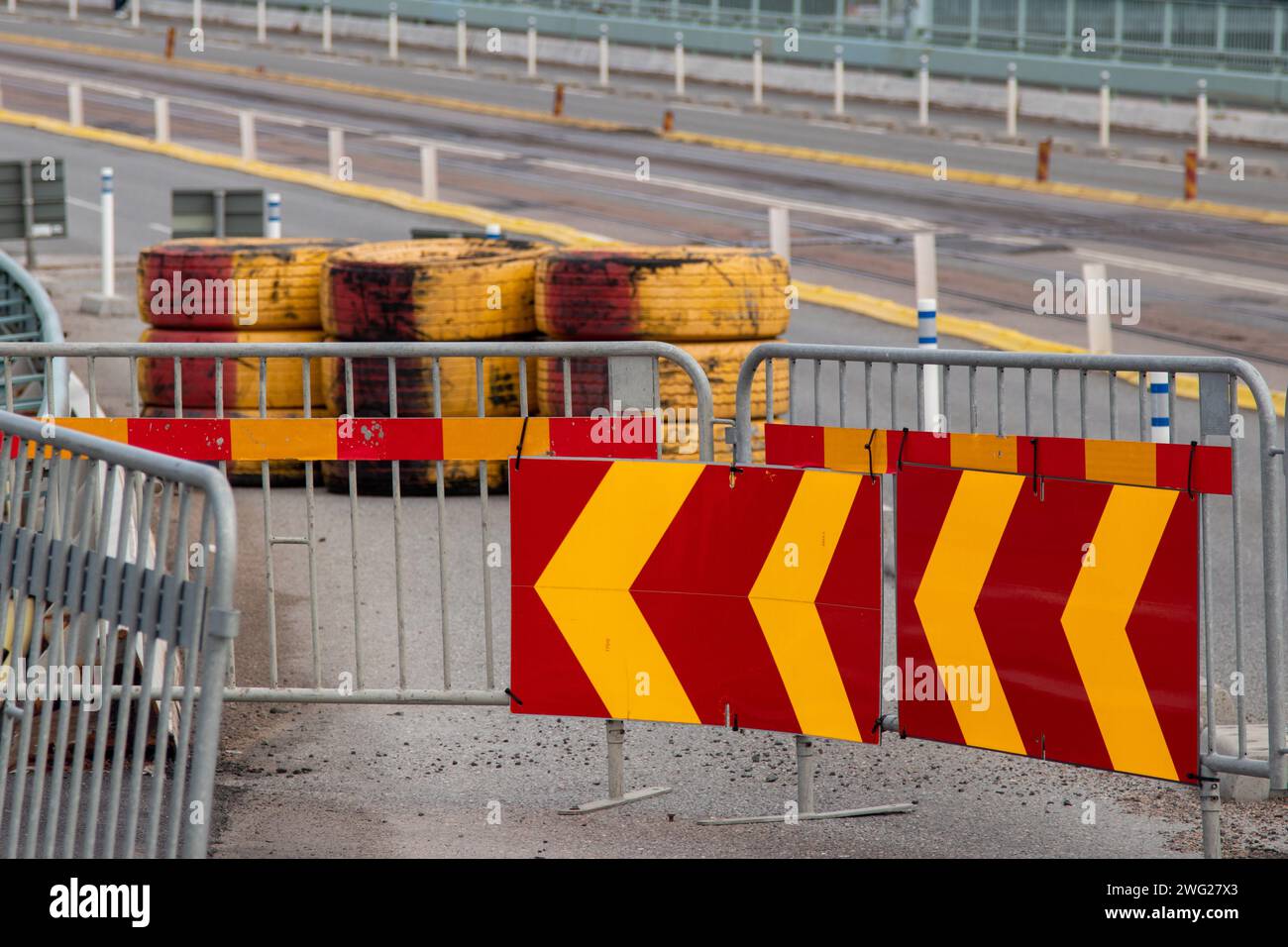 Sign for diverting traffic and tyres as obstacles on a road ...