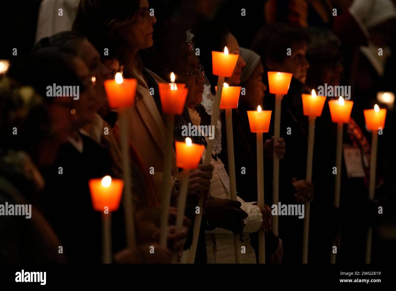 People hold candles during a mass for the religious orders with Pope ...