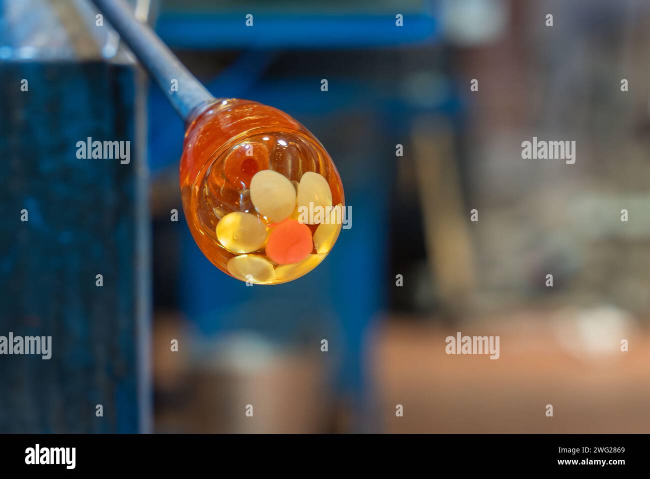 Glassblowing. Molten glass on edge of pontil. Manual process of glass ...