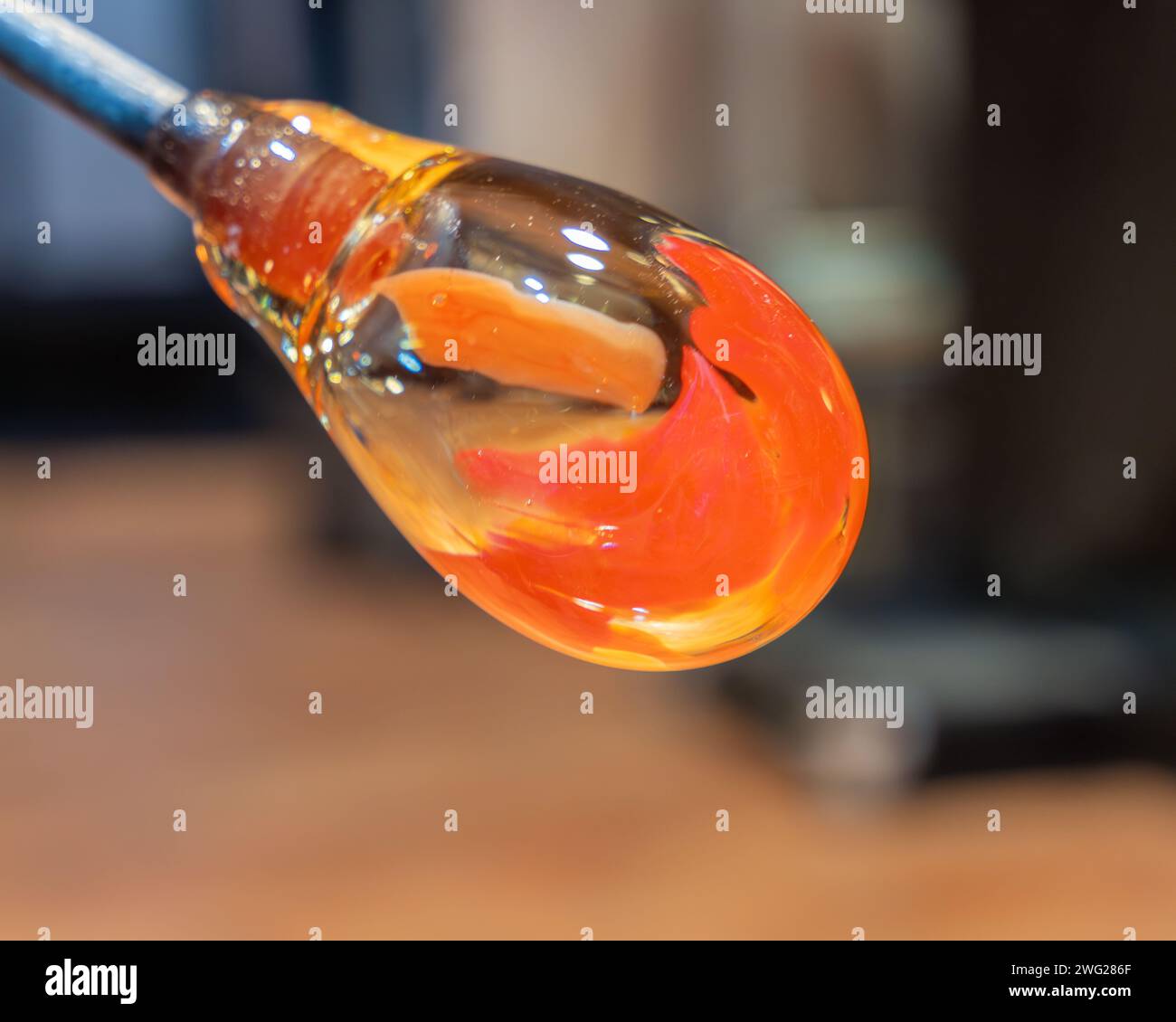 Glassblowing. Molten glass on edge of pontil. Manual process of glass ...