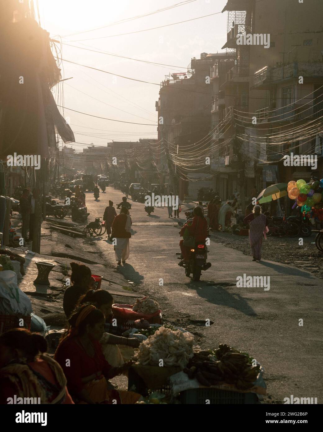 A typical street view of a Nepali city at sunset. Taken in ...