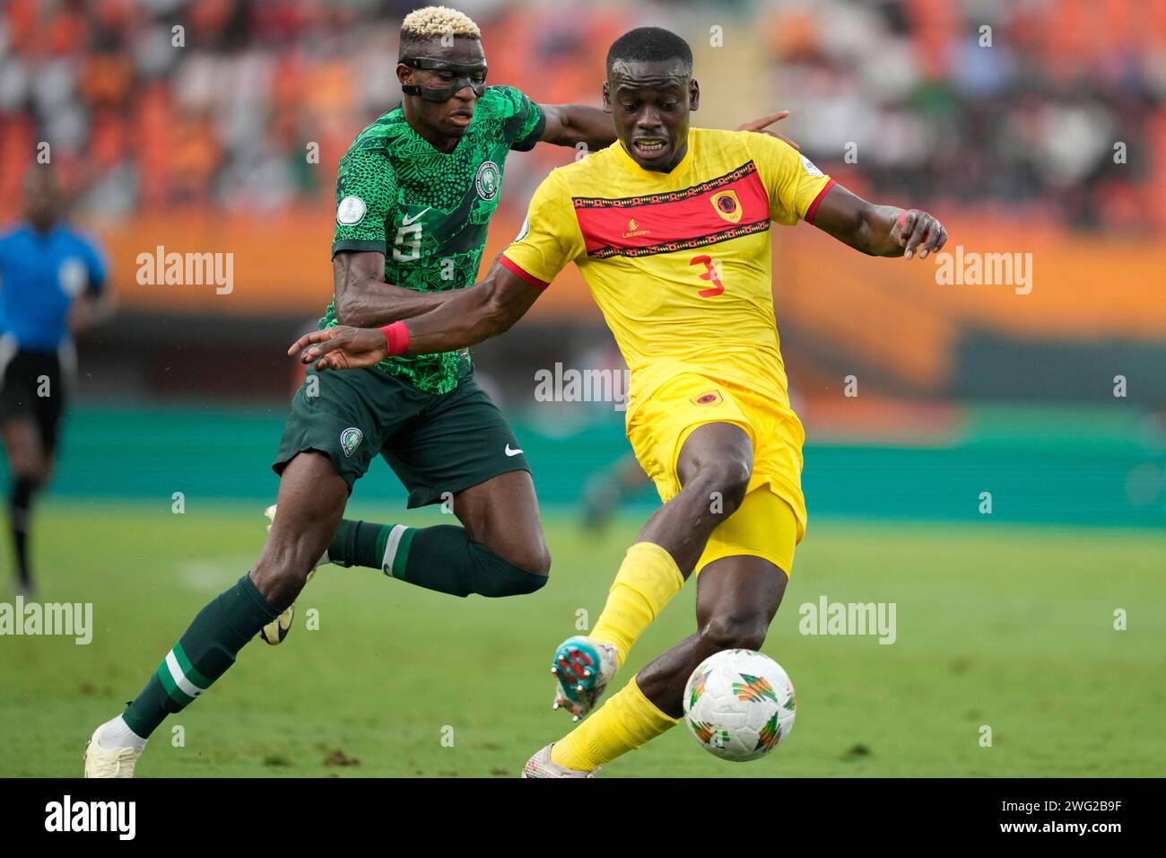 Nigeria's Victor Osimhen, left, challenges Angola's Jonathan Buatu ...