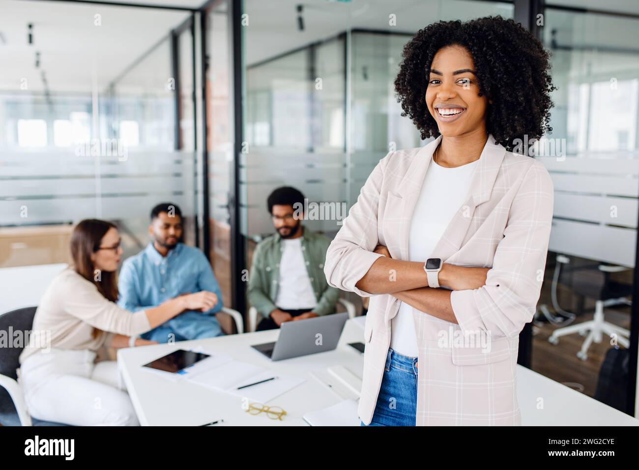 Smart high-skilled young Brazilian woman with a cheerful smile stands ...