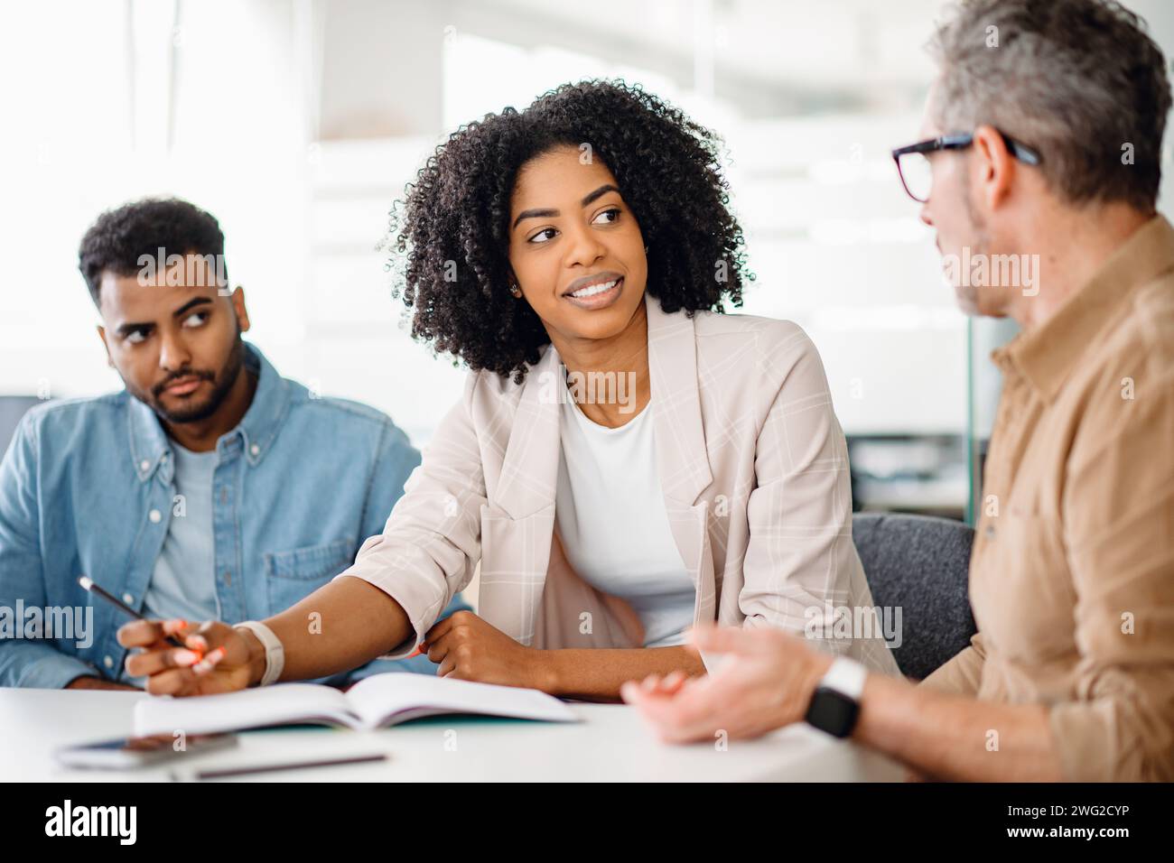 Smart and intelligent African-American businesswoman in a white blazer ...
