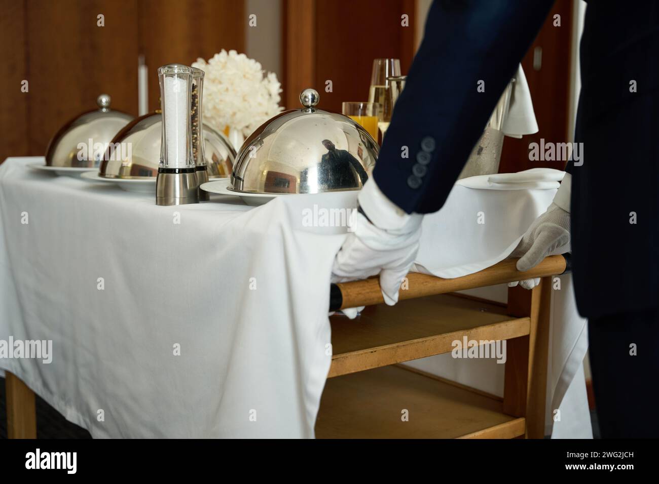 Hotel staff delivers restaurant food to your room Stock Photo - Alamy