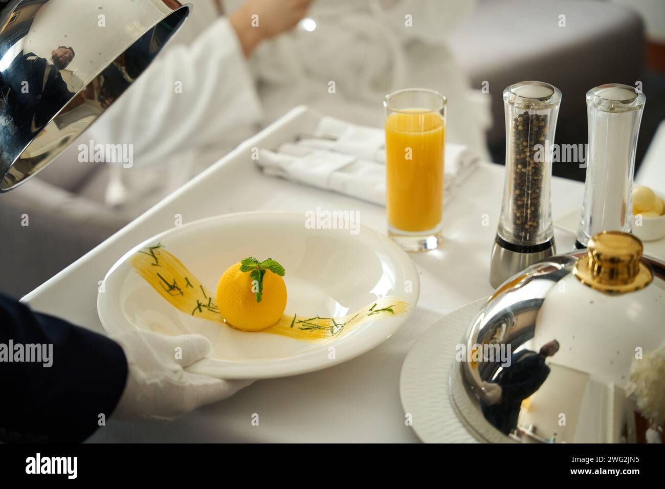 Waiter serves breakfast to a hotel guest in bed Stock Photo - Alamy
