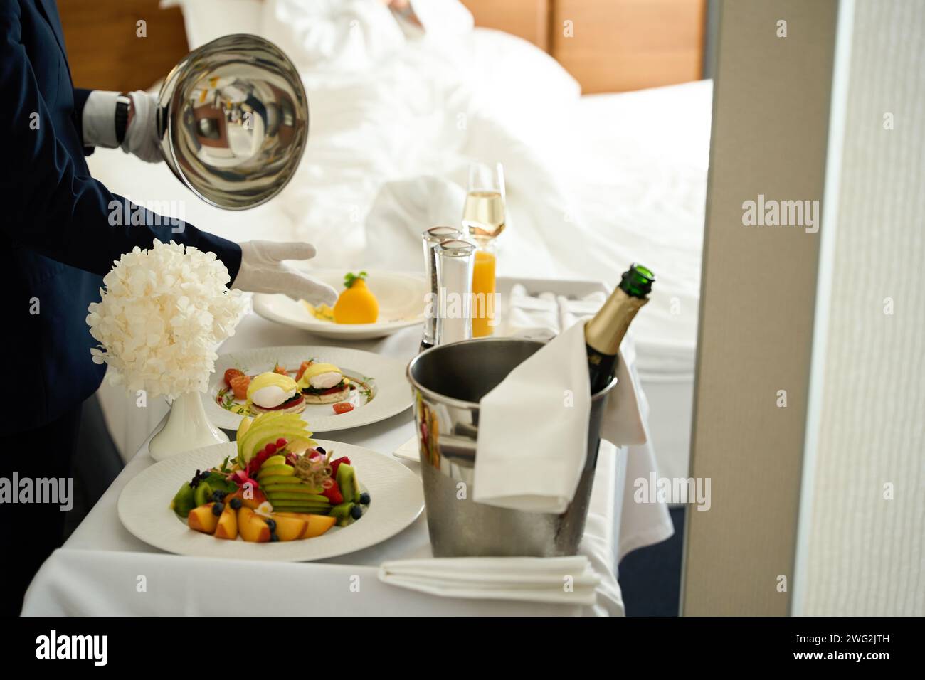 Serving breakfast in the room with champagne on serving table Stock ...