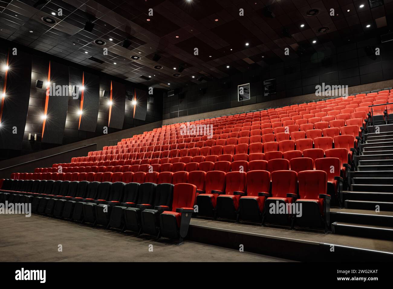 Empty cinema hall interior with row of red seats waiting for visitors Stock Photo - Alamy