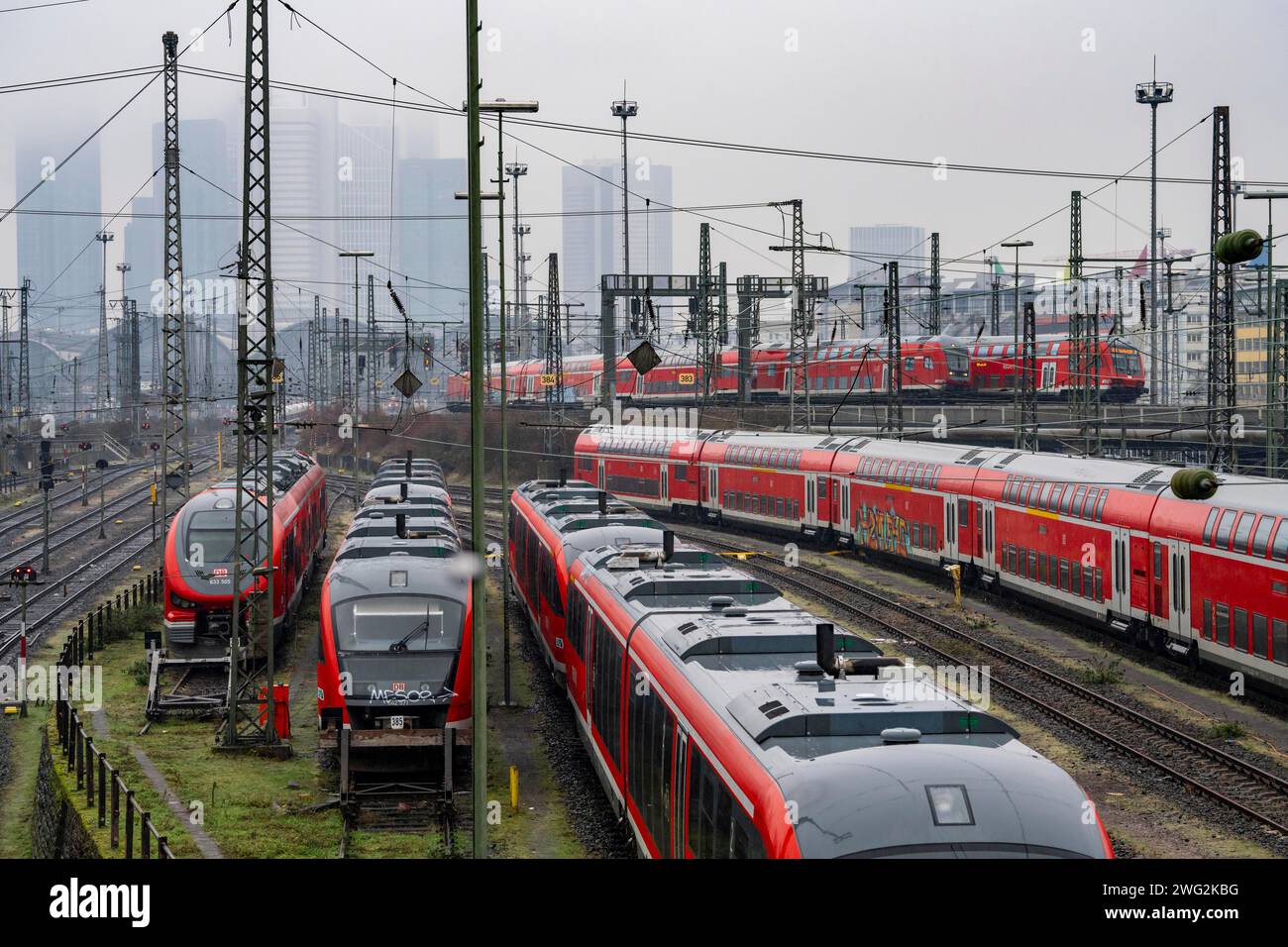 Railway tracks with regional trains, after freezing rain, in front of ...