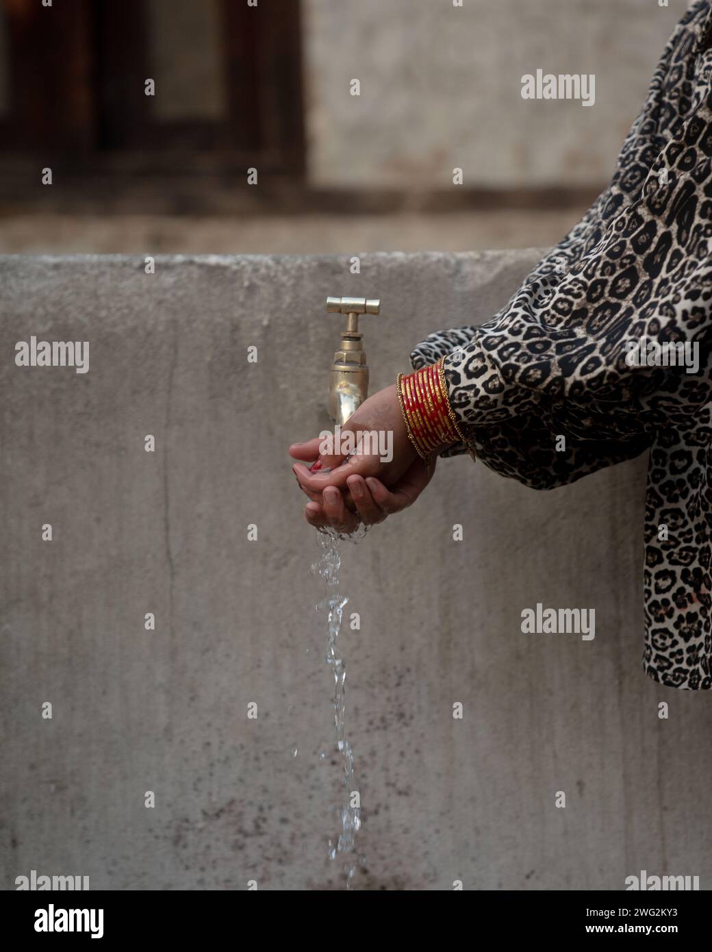 Nepalese children washing and drinking at a village/community water ...