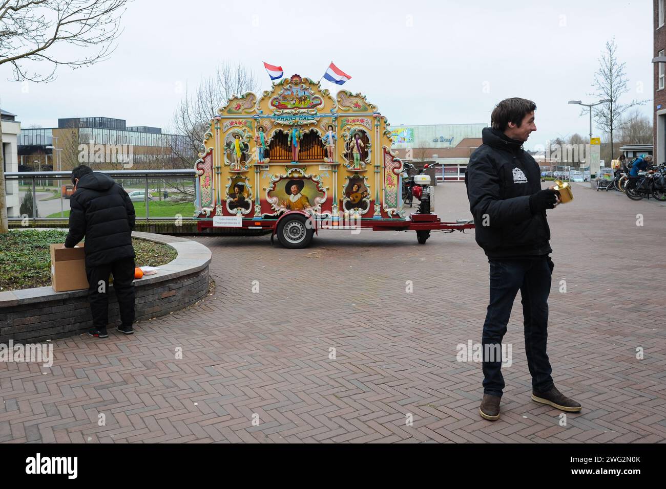 Organ man with collection box for a traditional Dutch barrel organ in ...