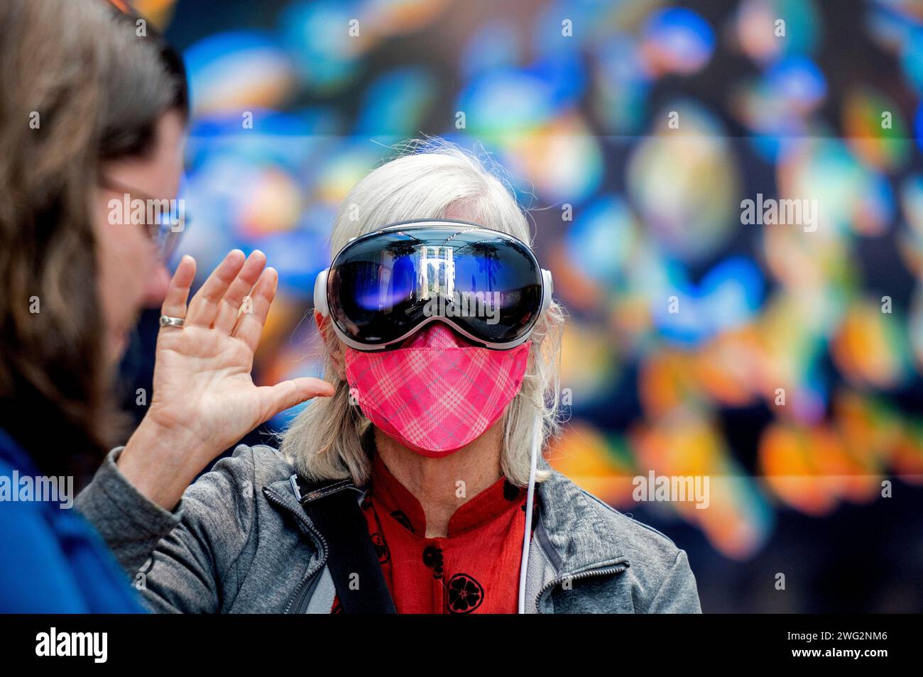 Kathy Corby tries out an Apple Vision Pro headset during the first day ...
