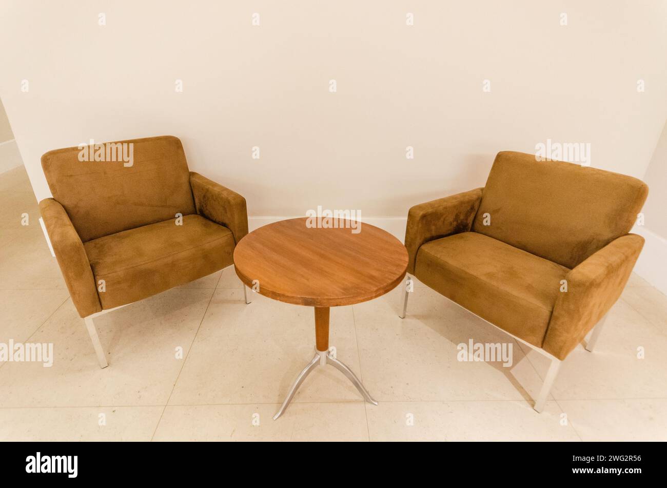 Two chairs arranged for a conversation in an empty room Stock Photo - Alamy