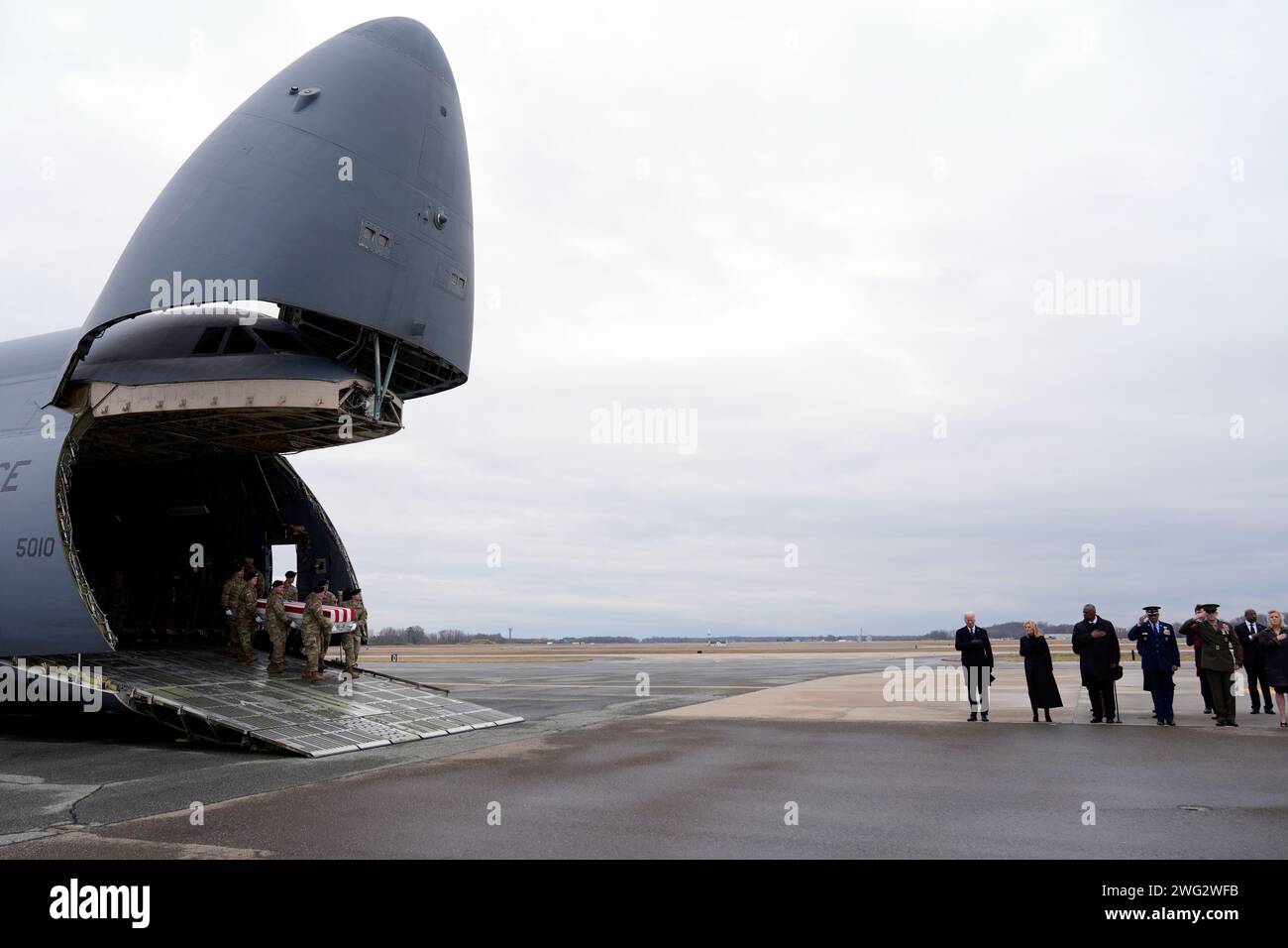 An Army carry team moves the flag-draped transfer case containing the ...