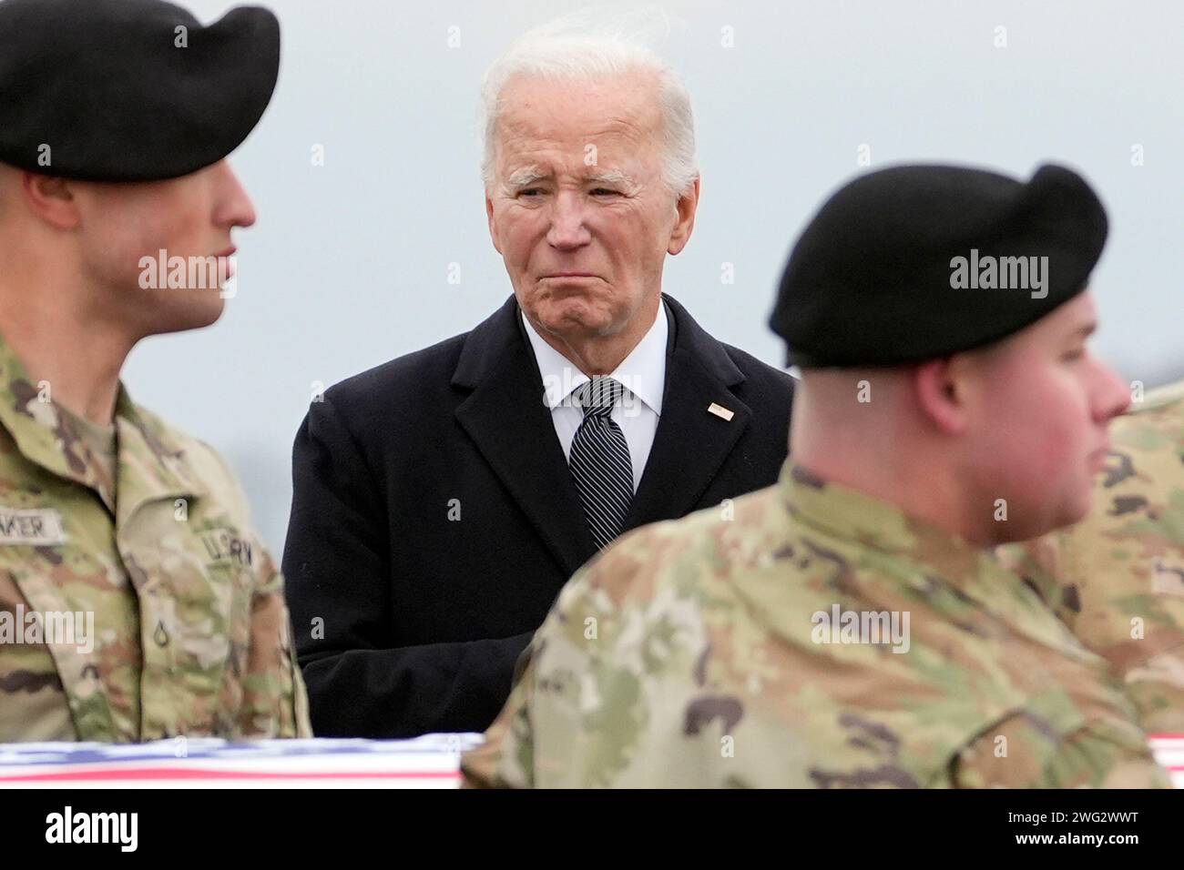 President Joe Biden watches as an Army carry team moves the flag-draped ...