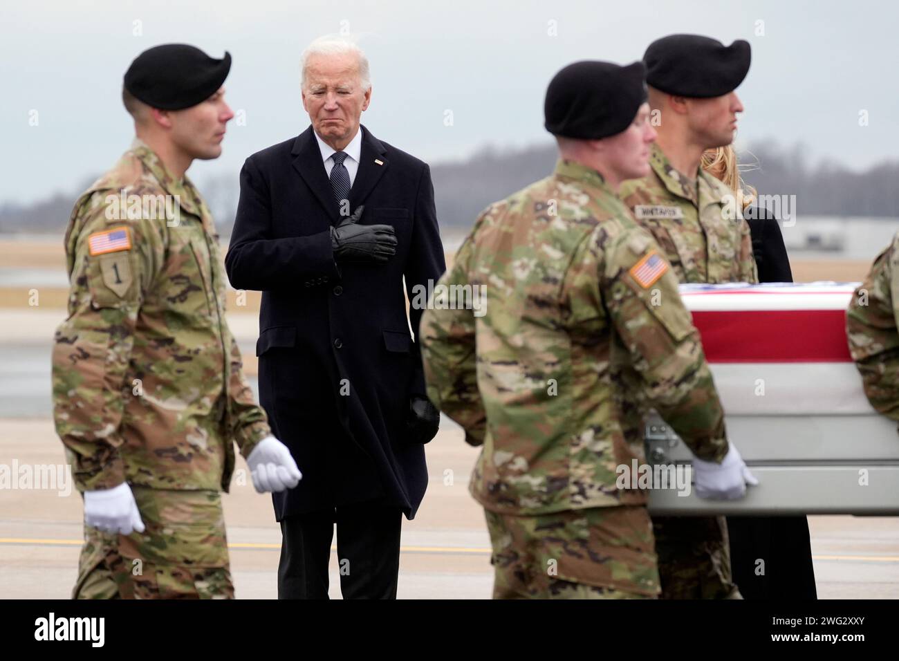 President Joe Biden watches as an Army carry team moves the flag-draped ...
