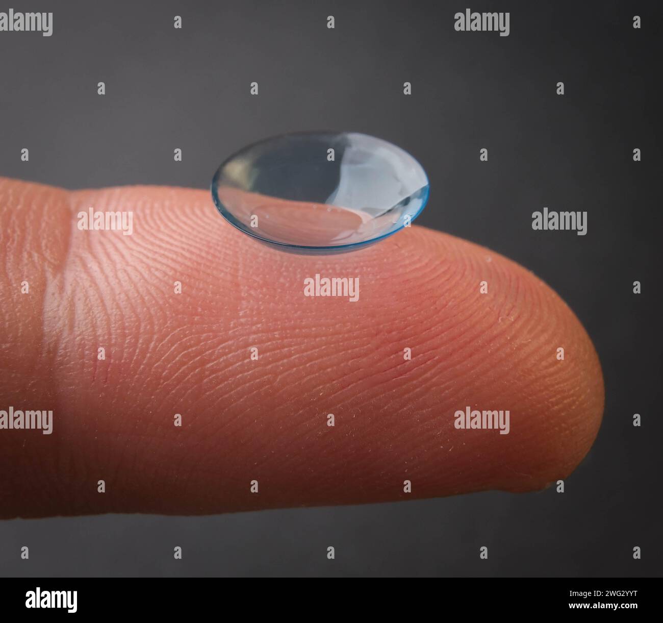 solid contact lens on finger Stock Photo - Alamy