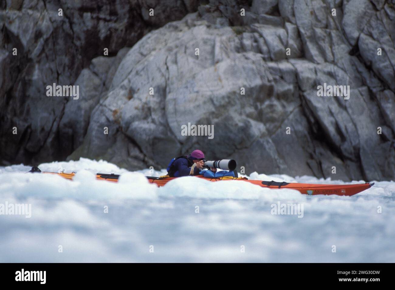 photographer John Schweider takes photos from his kayak in the ice in ...