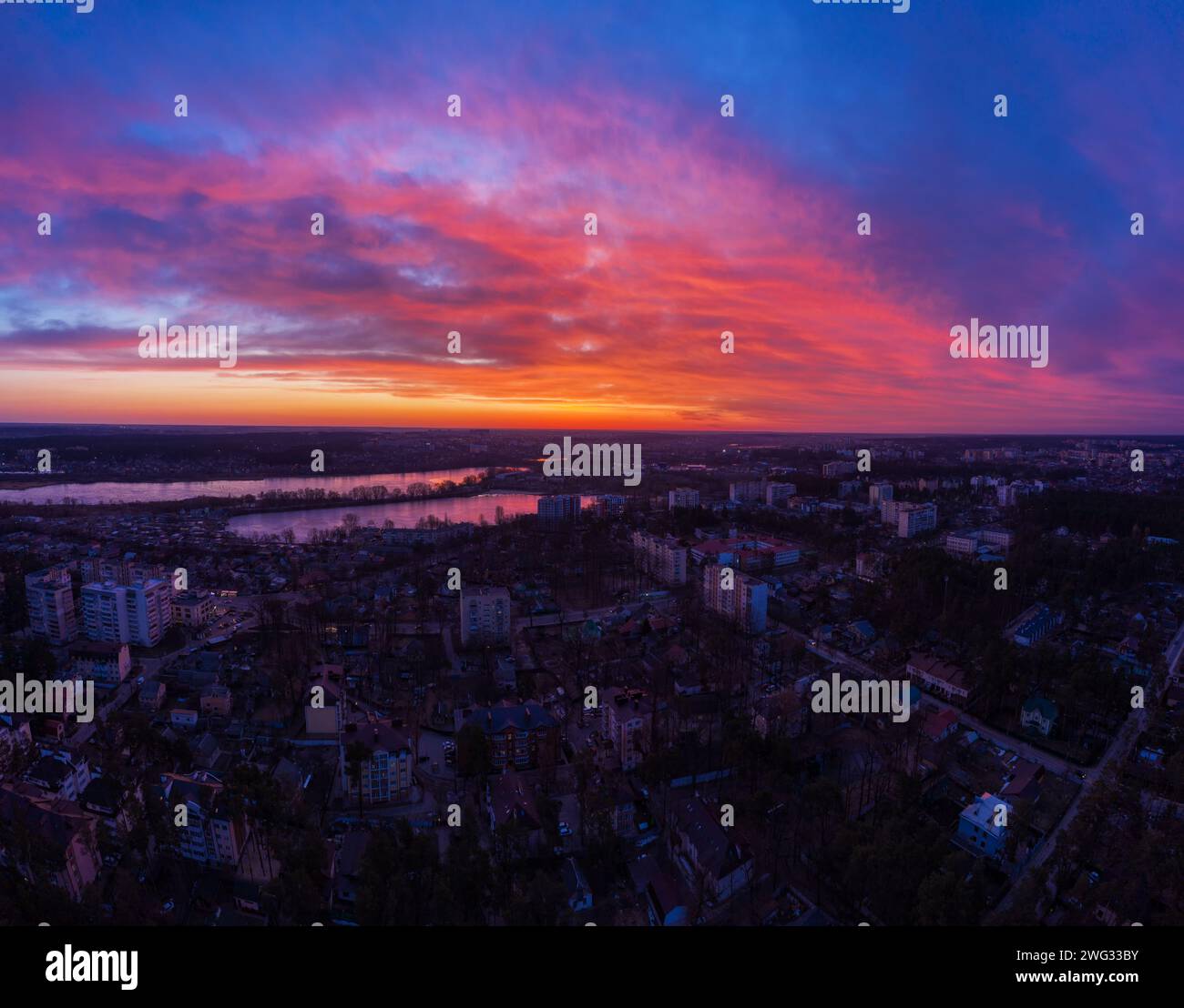 Aerial view of dramatic sunset sky with clouds above the city at dusk ...