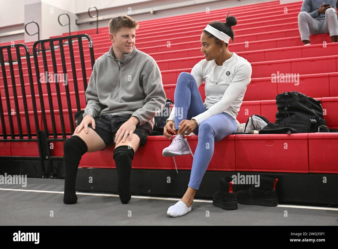 Olympic long jumper Tara Davis-Woodhall, right, sits with her husband ...
