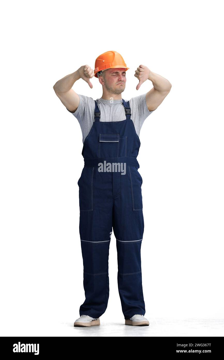 The builder, on a white background, in full height, shows his thumbs ...