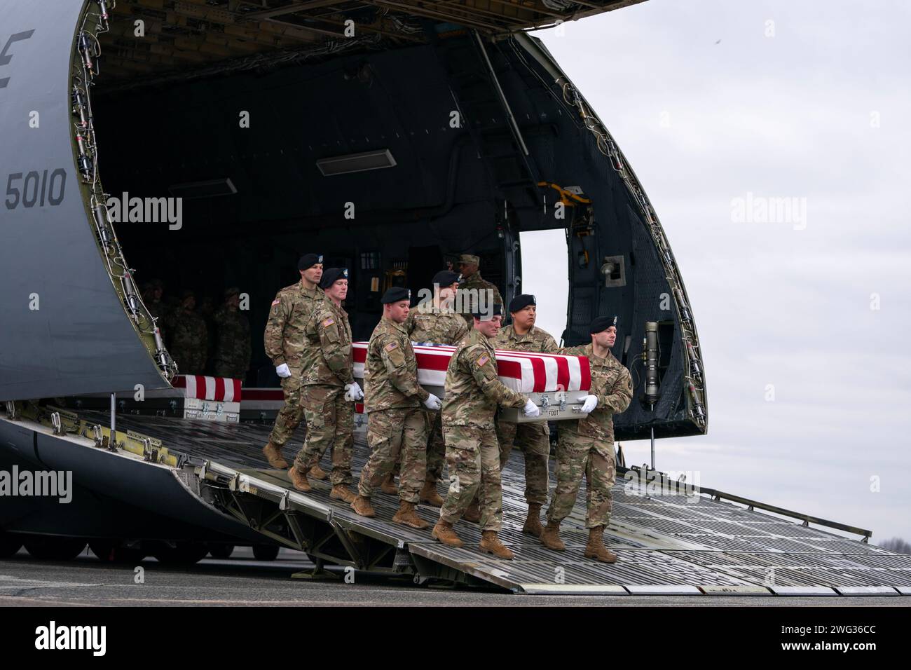 A U.S. Army carry team moves a flagged draped transfer case containing the remains of Army Sgt ...