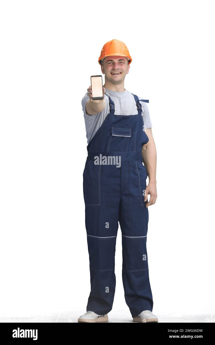 A builder, on a white background, in full height, with a phone Stock ...