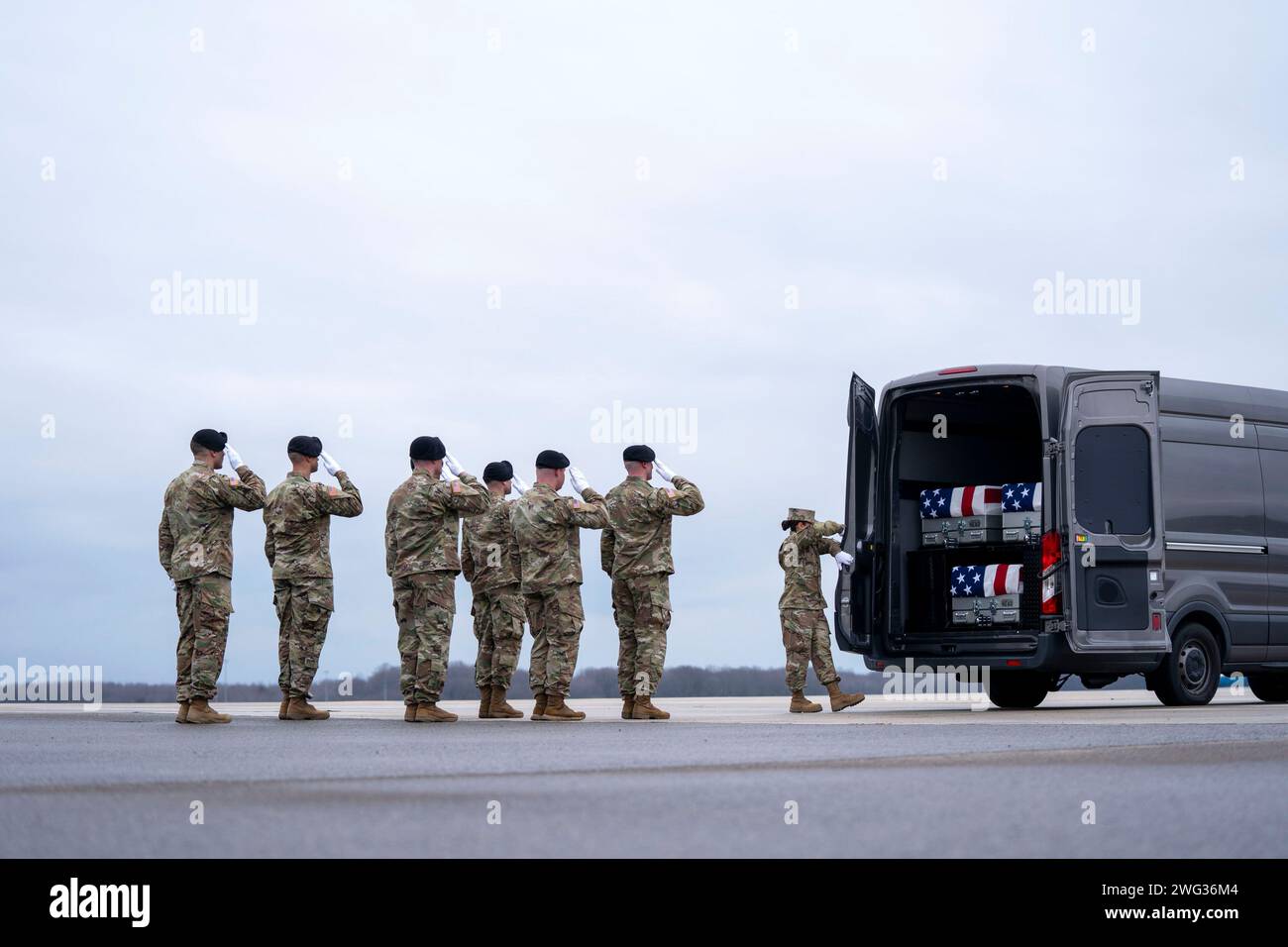 A U.S. Army carry team salutes as the transfer vehicle carrying the ...