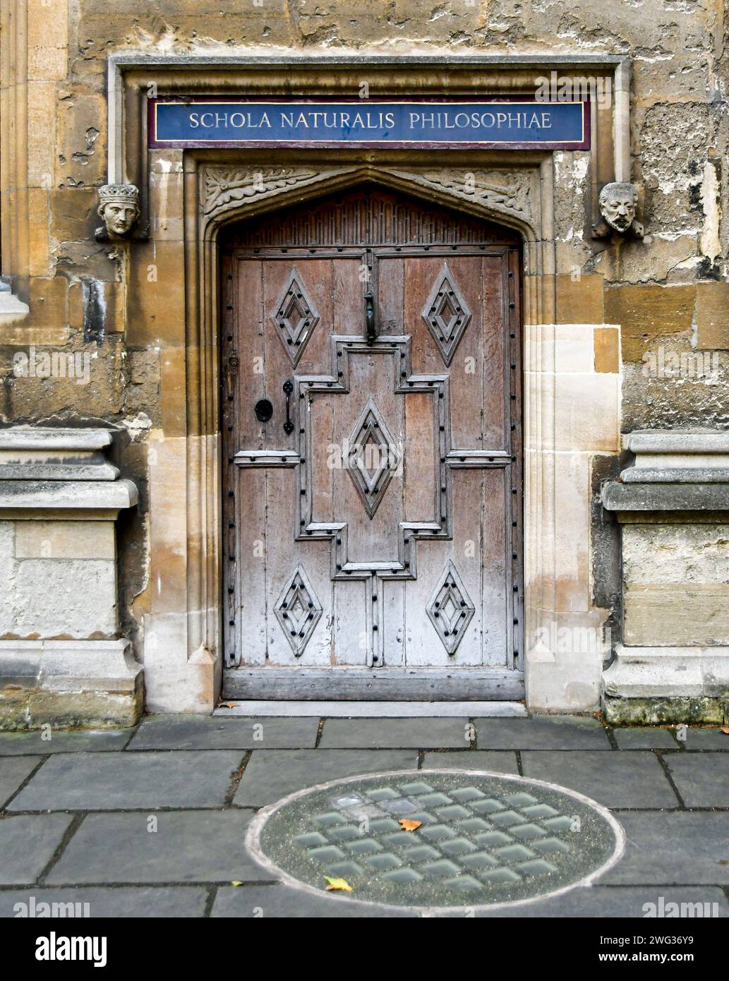 A front entrance of a building adorned with exquisite wooden doors and ...