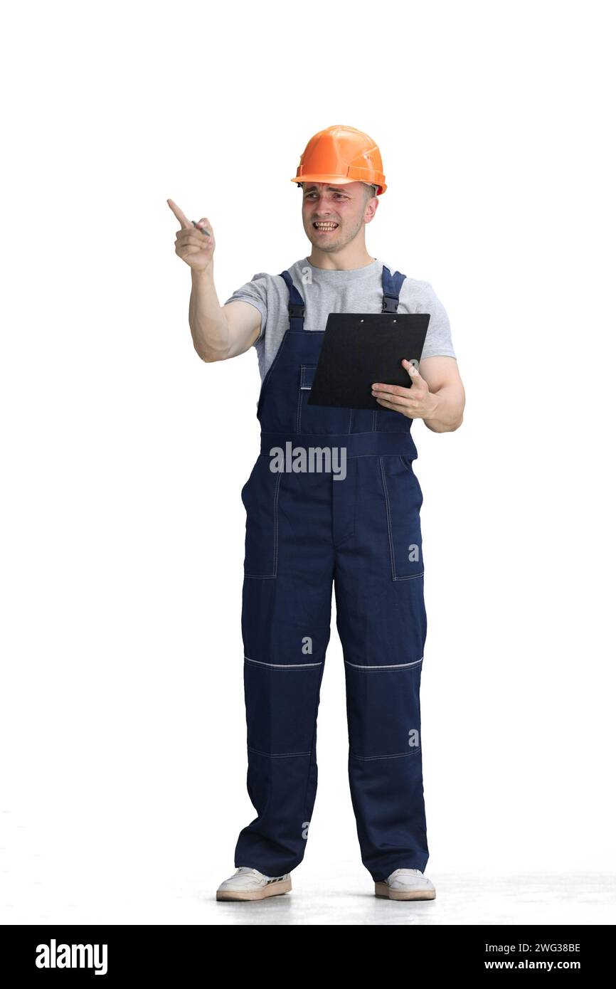 The builder, on a white background, in full height, points to the side ...