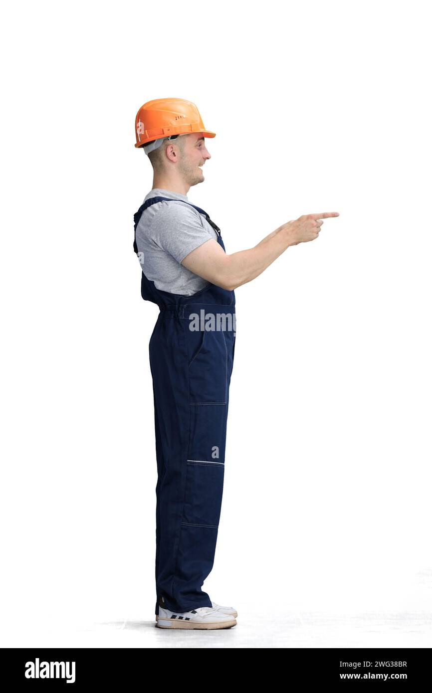 The builder, on a white background, in full height, points to the side ...
