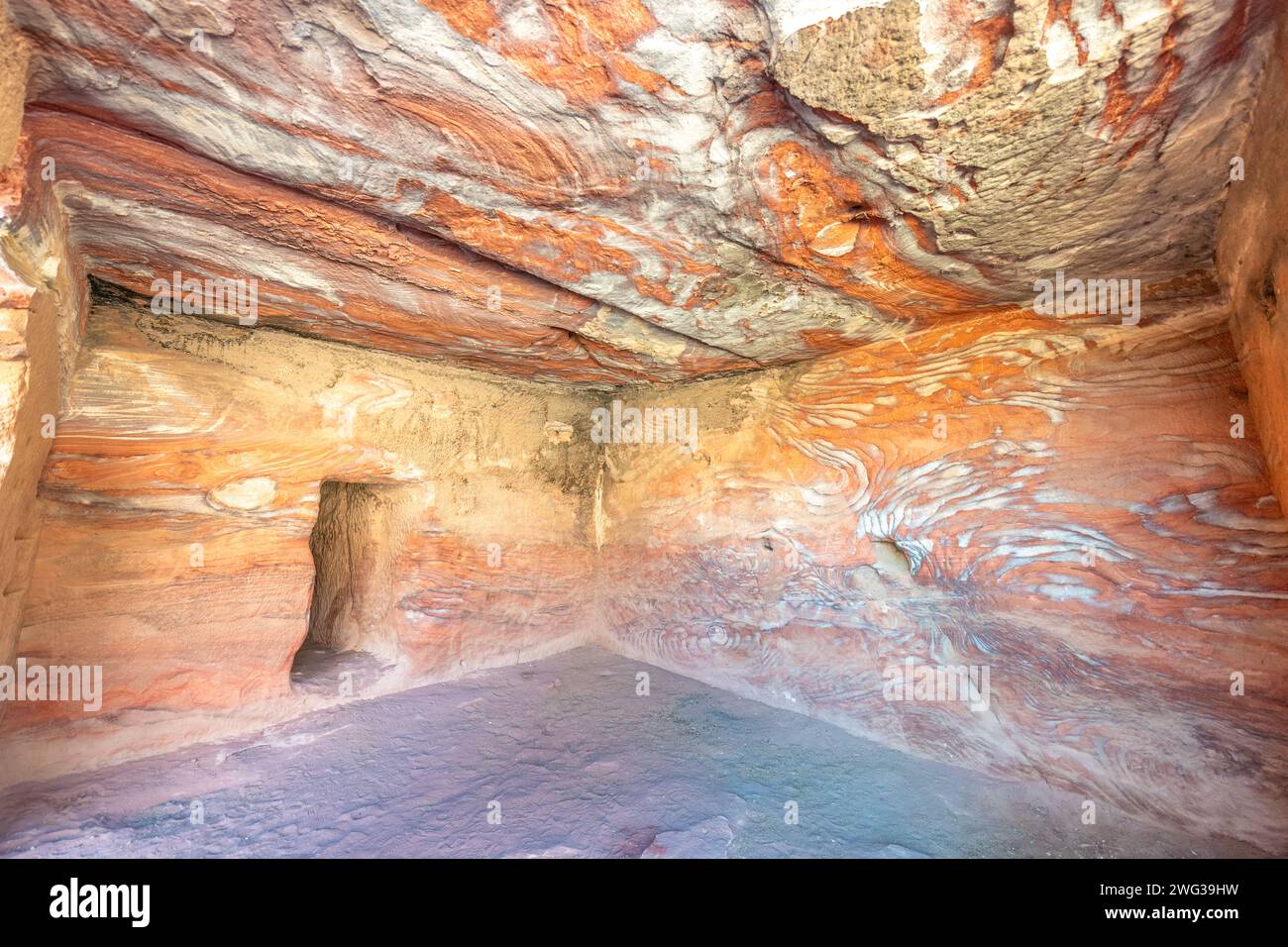 Title: A colourful sandstone cut out cave in the city of Petra in ...