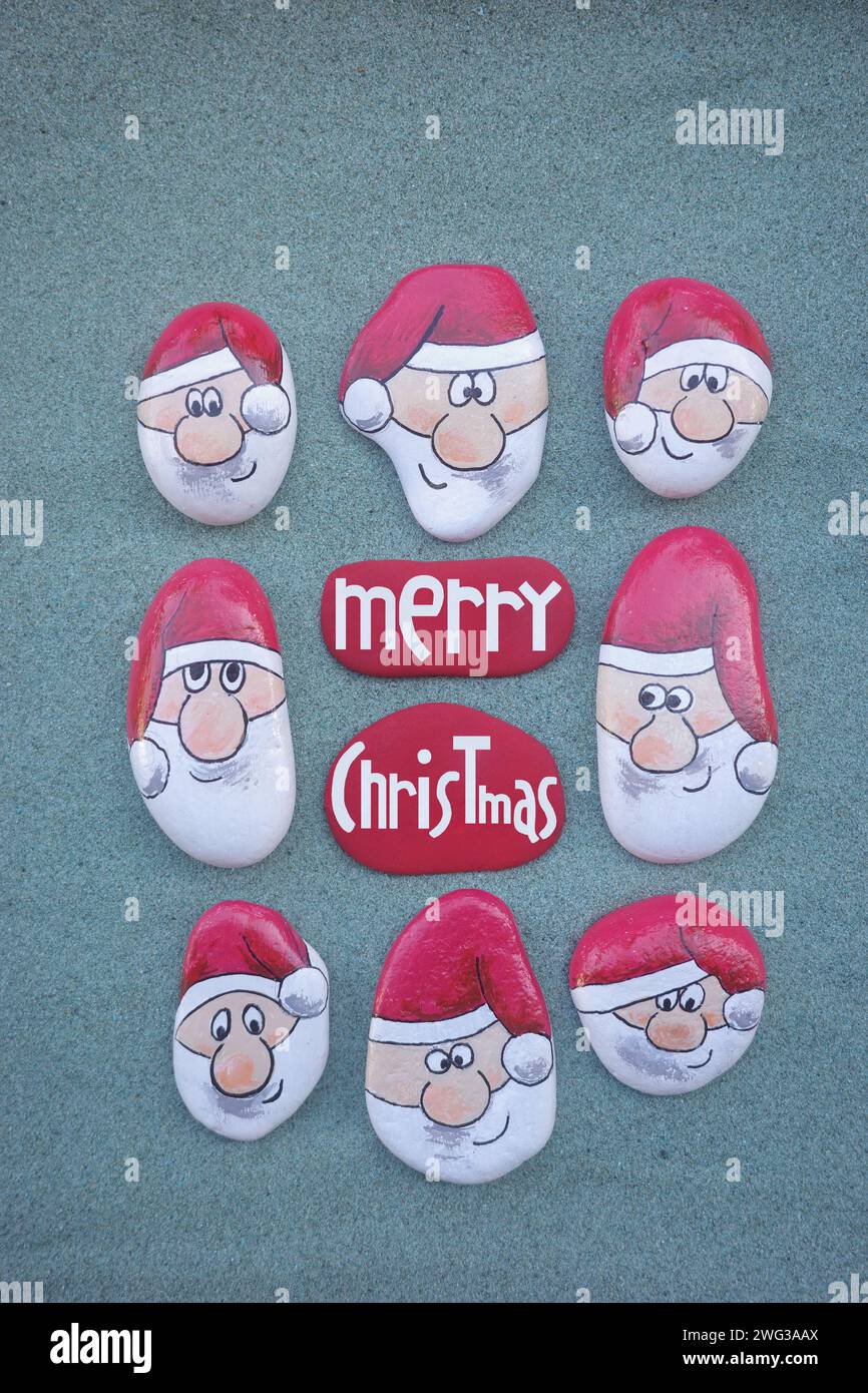 Merry Christmas message composed with hand painted Santa Claus stones ...