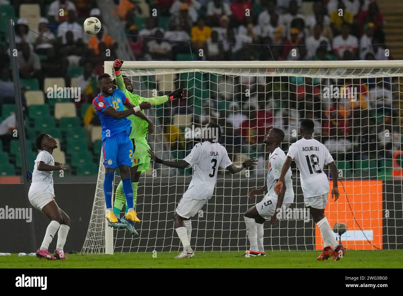Guinea's goalkeeper Ibrahim Kone makes a save in front of DR Congo's ...