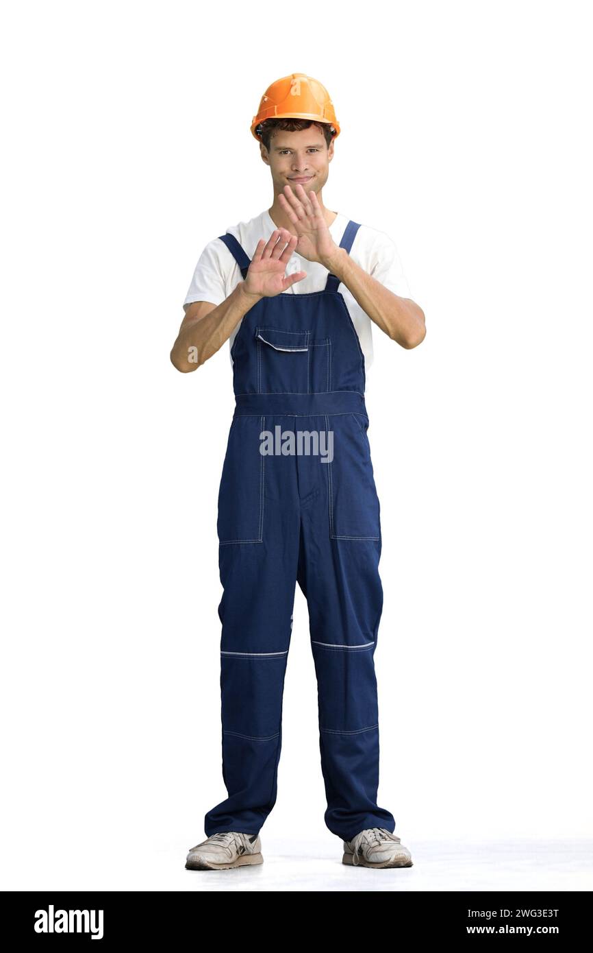 A male construction worker, on a white background, shows a stop sign ...