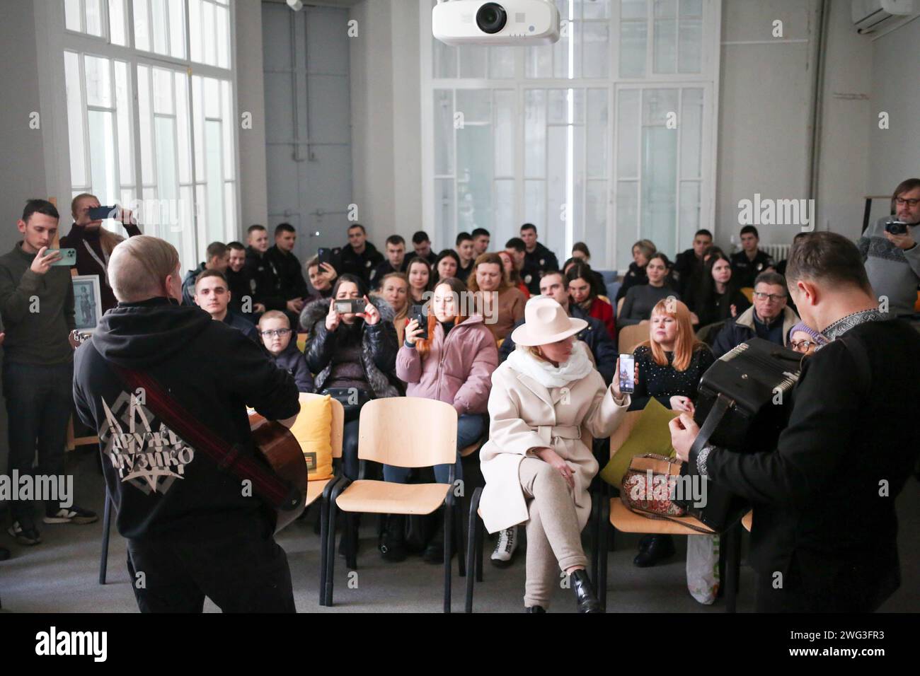 Druzhe Muzyko band perform at a memorial evening of Andriy Kuzmenko in front of the audience. An ...
