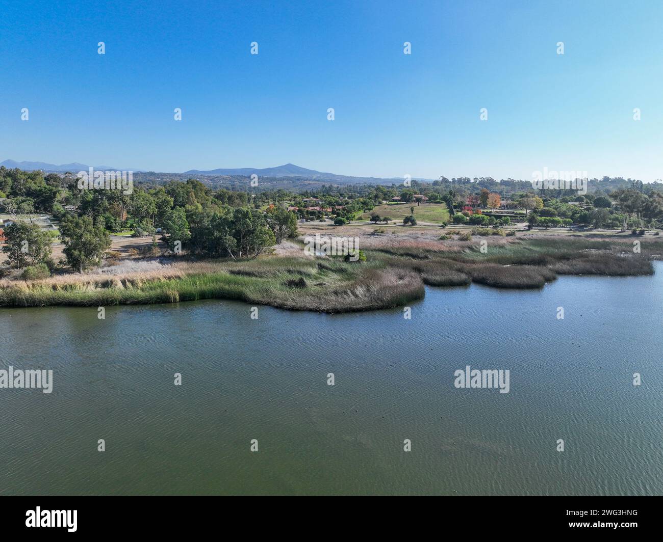 Aerial view over water reservoir and a large dam that holds water ...