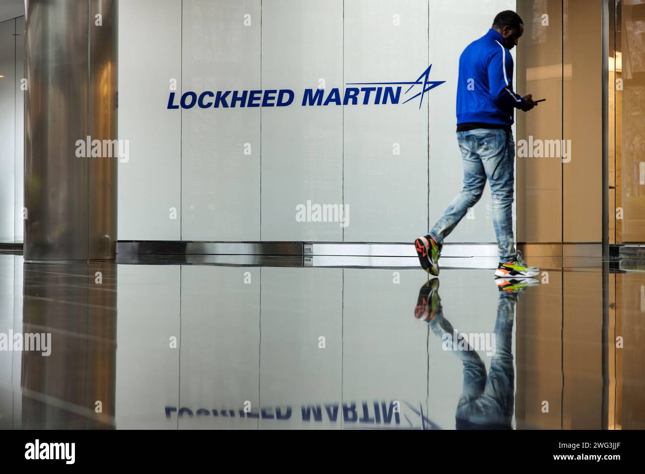 Arlington, United States. 02nd Feb, 2024. A man walks past the logo for ...