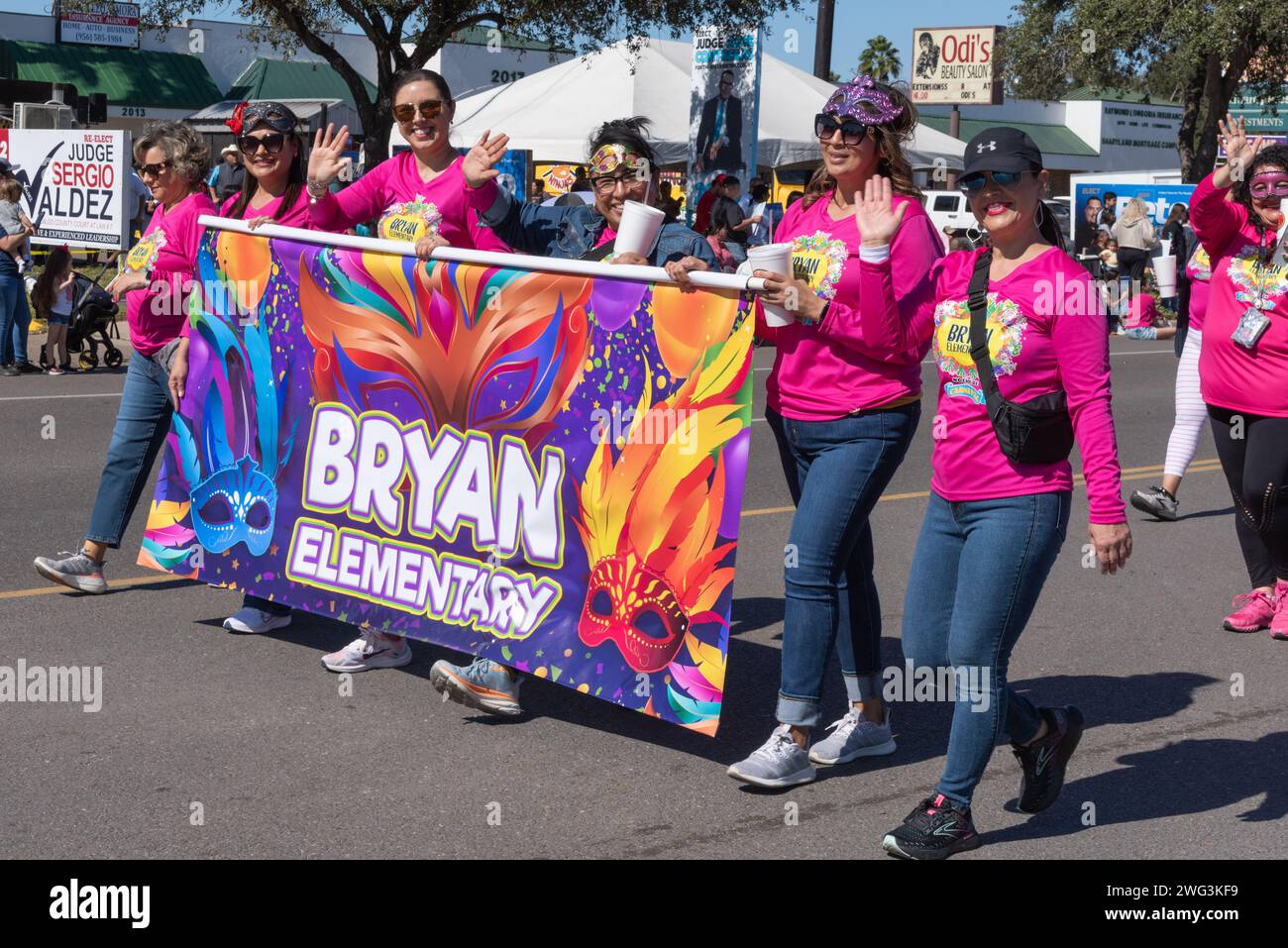 Women in bright pink shirts walk for Bryan Elementary in Parade of ...