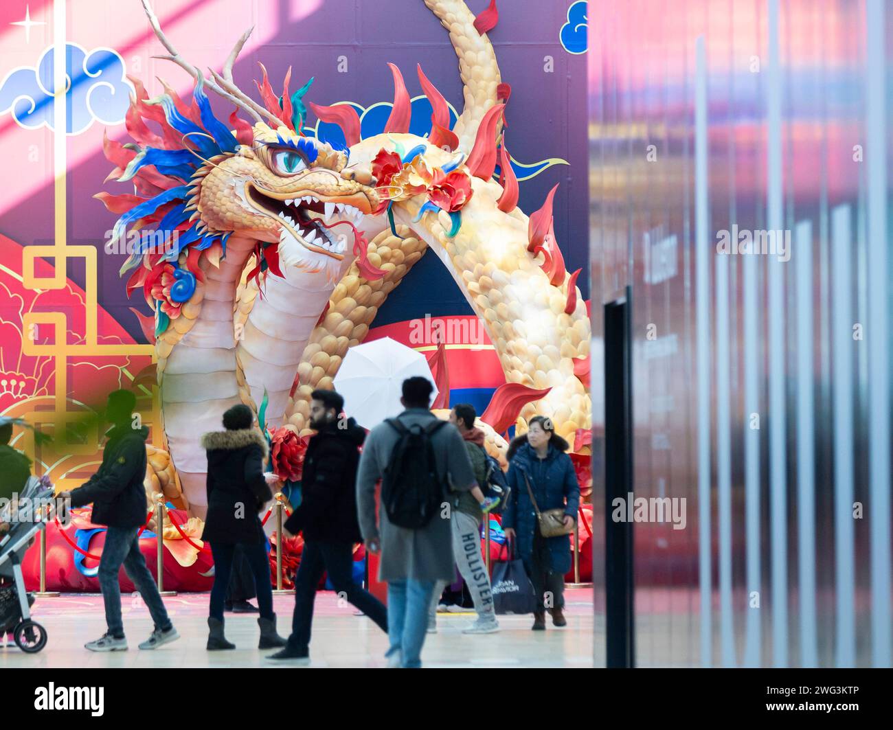 Toronto, Canada. 2nd Feb, 2024. People walk past a giant dragon ...
