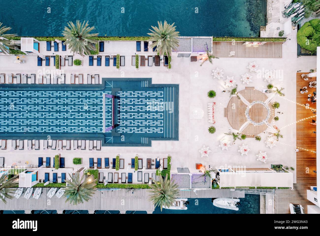 Long pool on the pier near a round stage with festive tables set. Top ...