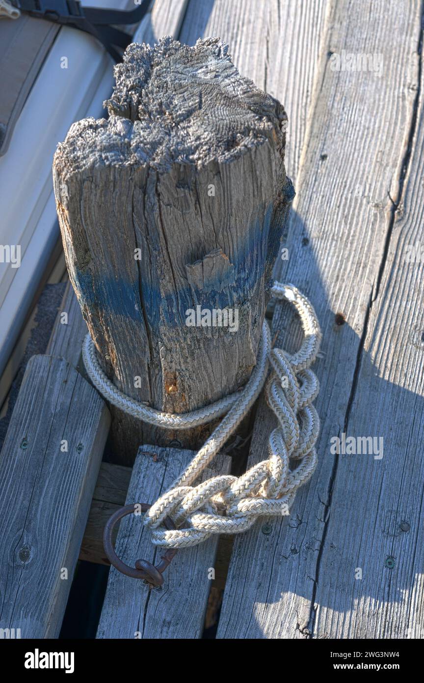 Old worn out wooden mooring post on a fishing boat pier Stock Photo - Alamy