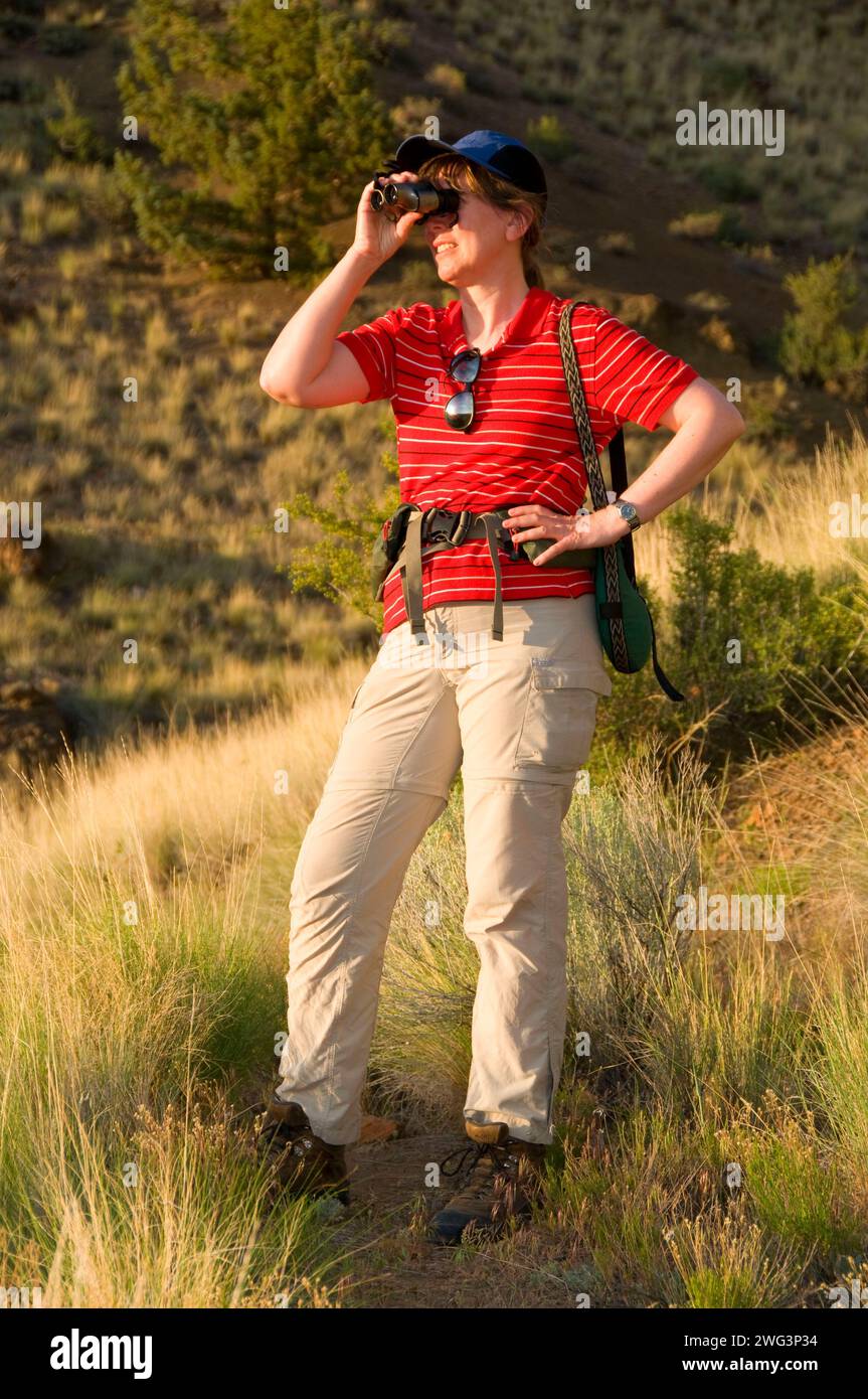 Hiker on grassland trail, Spring Basin Wilderness, Prineville District ...