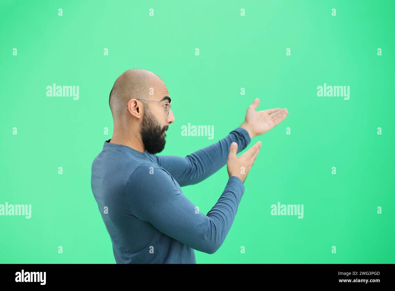 A man, on a green background, in close-up, points forward Stock Photo ...
