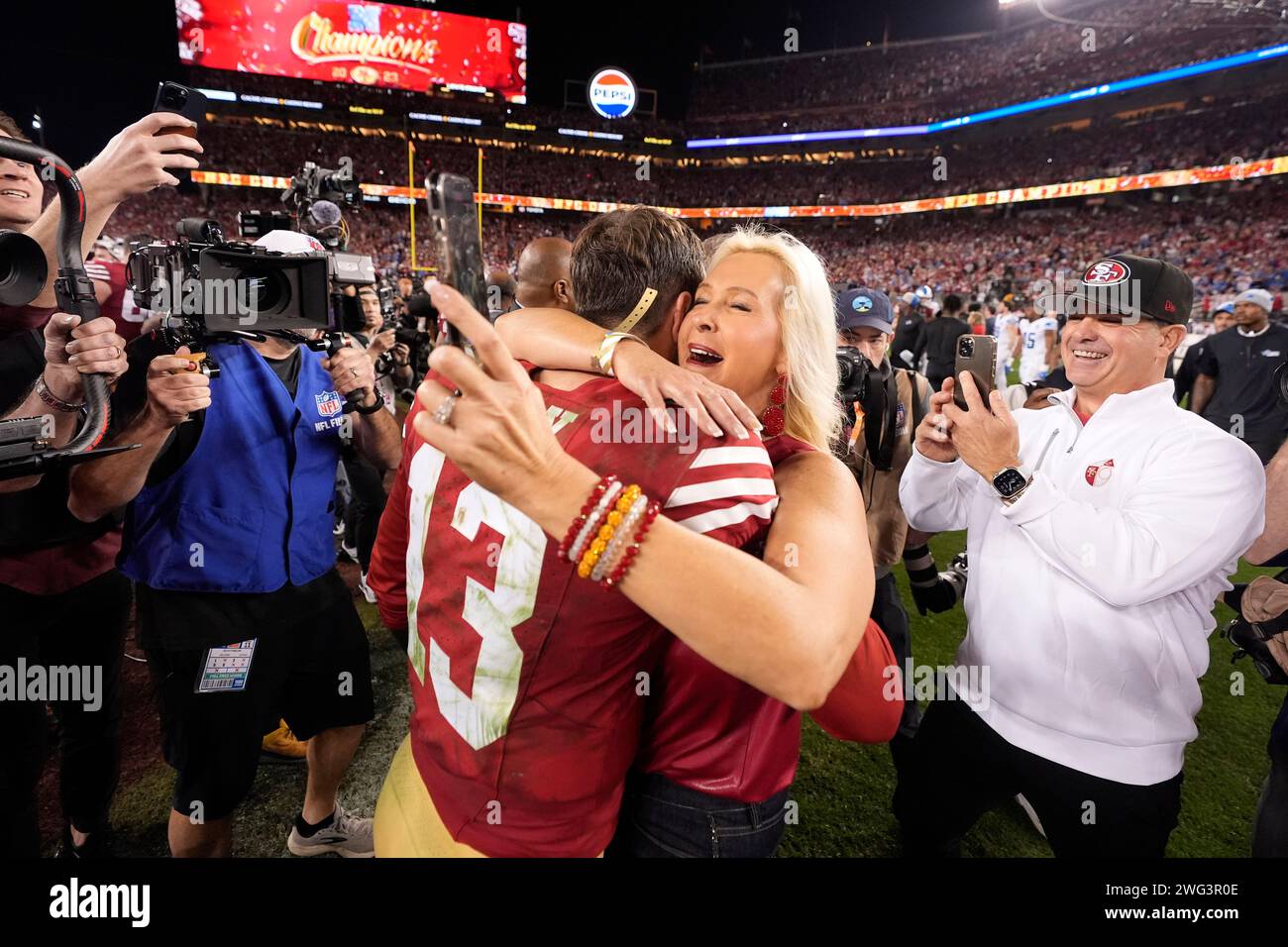 San Francisco 49ers quarterback Brock Purdy, left, hugs his mother ...